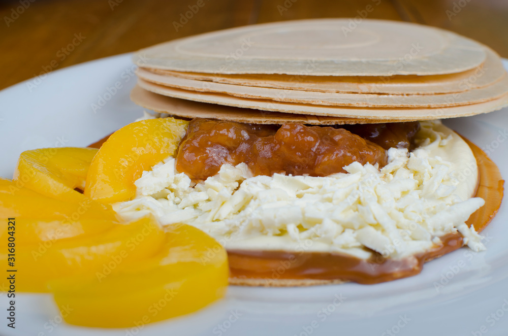 Wafer, traditional Colombian dessert, chopped fruit cookie and sauces ...