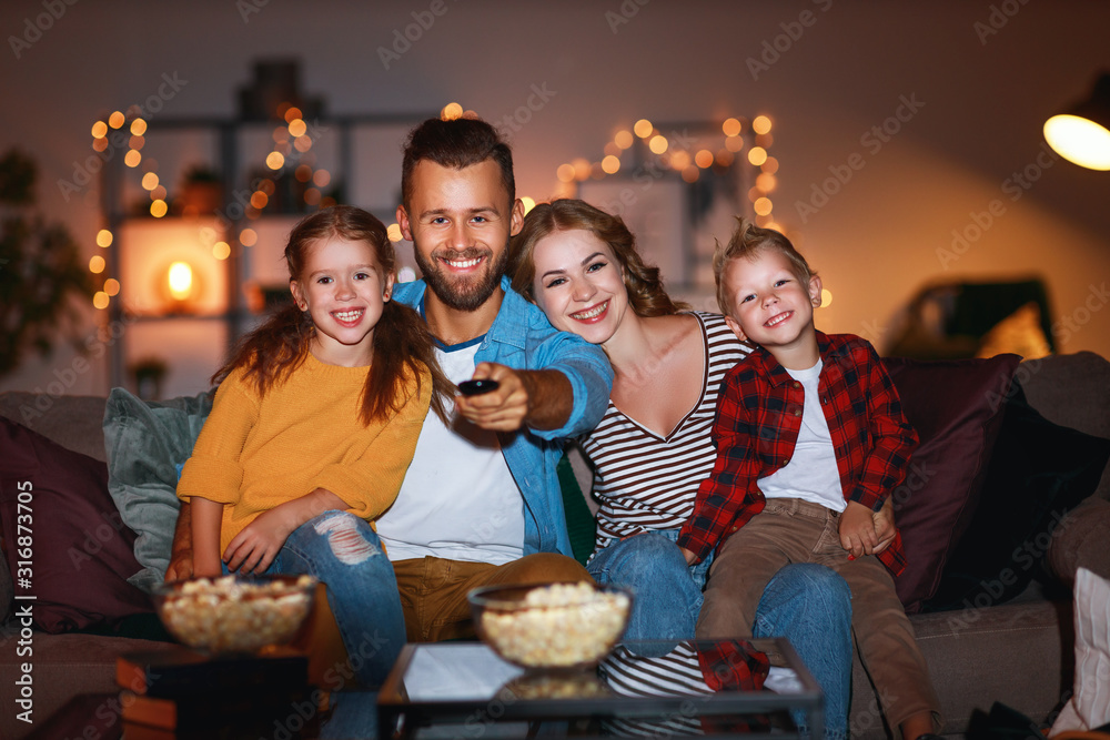 family mother father and children watching projector, TV, movies with ...