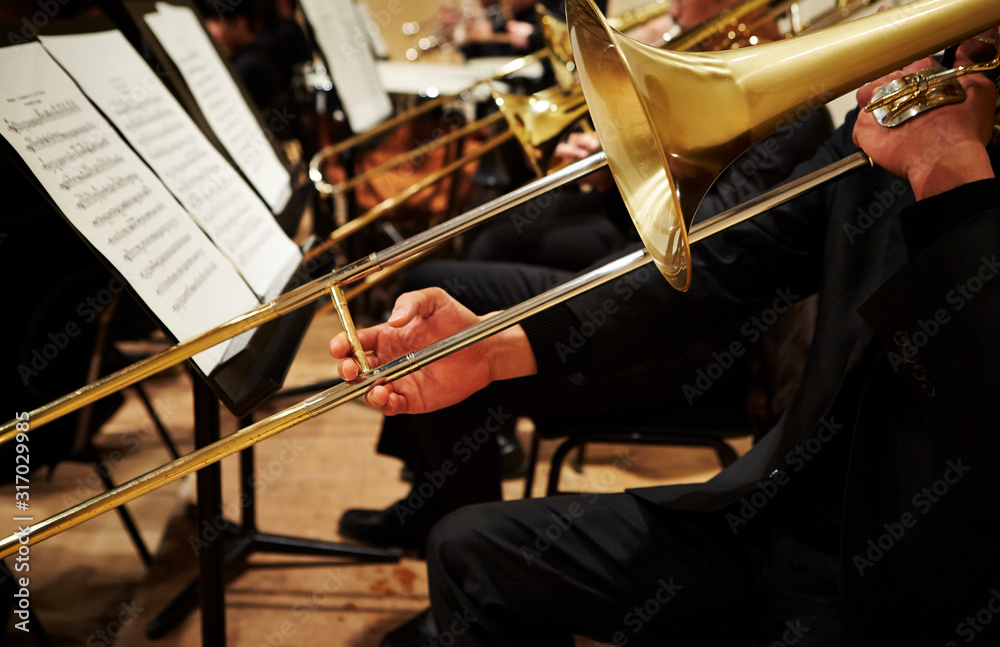 Playing the trombone in orchestra Stock Photo | Adobe Stock