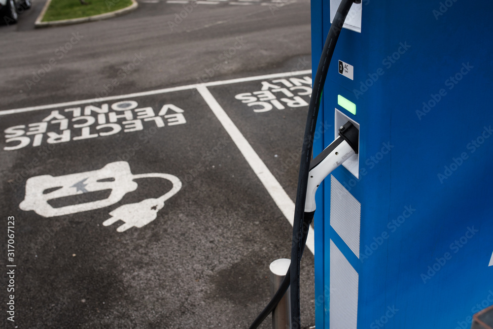 Car battery charging point and the white plug. Stock Photo | Adobe Stock