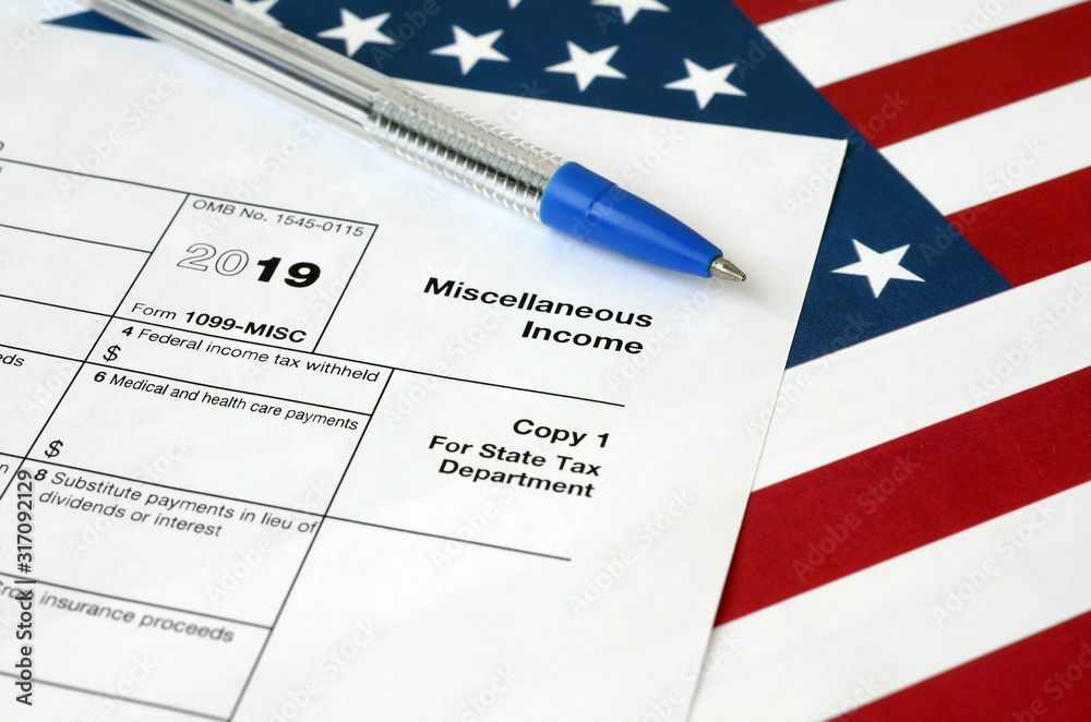 Form 1099-misc Miscellaneous income and blue pen on United States flag ...