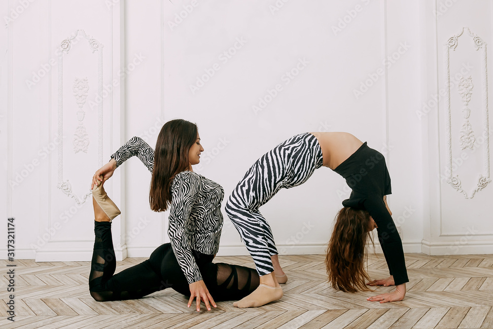 Rhythmic gymnastics. Girls gymnasts, performs various gymnastic ...