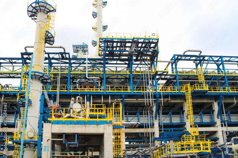 Iron metal industrial plant installations with stairs, fences and pipes ...