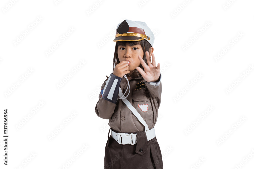 Asian little girl wearing a police uniform with a whistle blowing and ...
