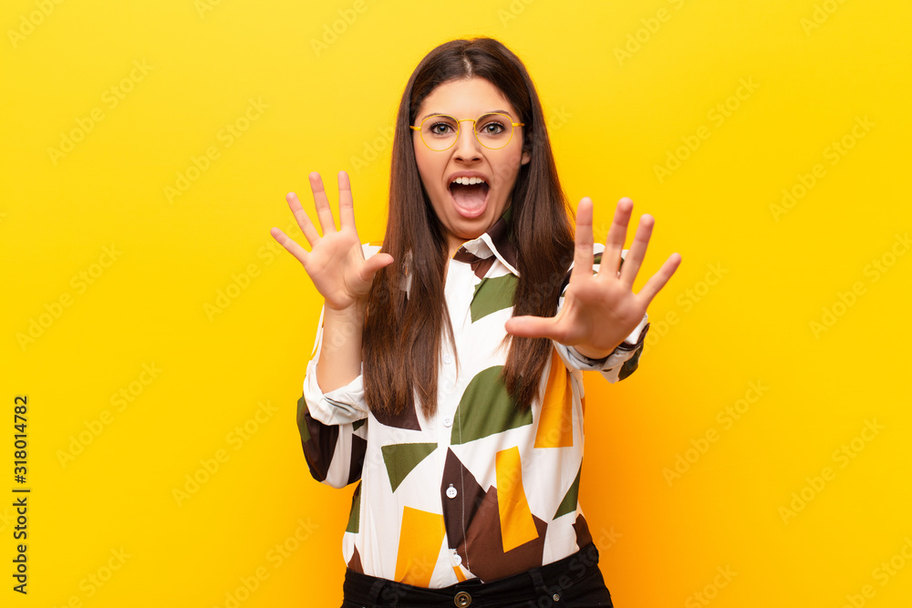 young pretty woman feeling terrified, backing off and screaming in ...