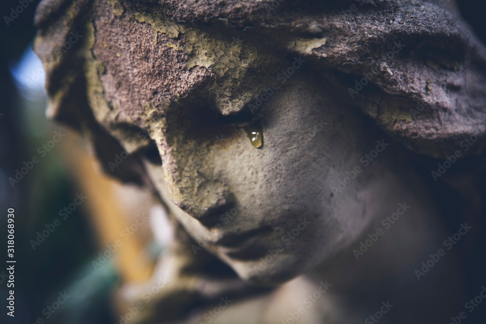 Death concept. Close Up of ancient statue of crying angel with tears in ...