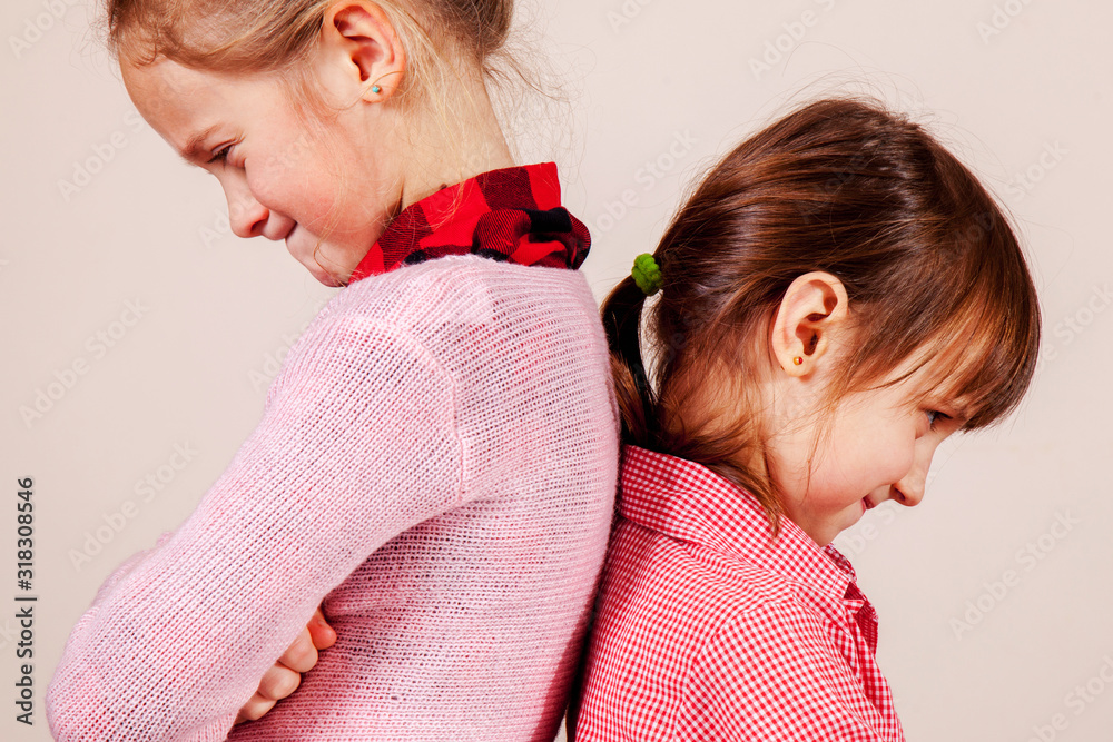 Quarrel and insult between two child girls or sisters. Close up sad ...