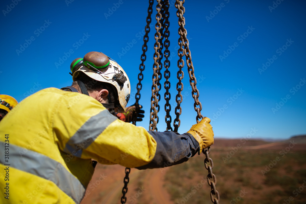 Trained competent safe work practice rigger wearing a leather safety ...