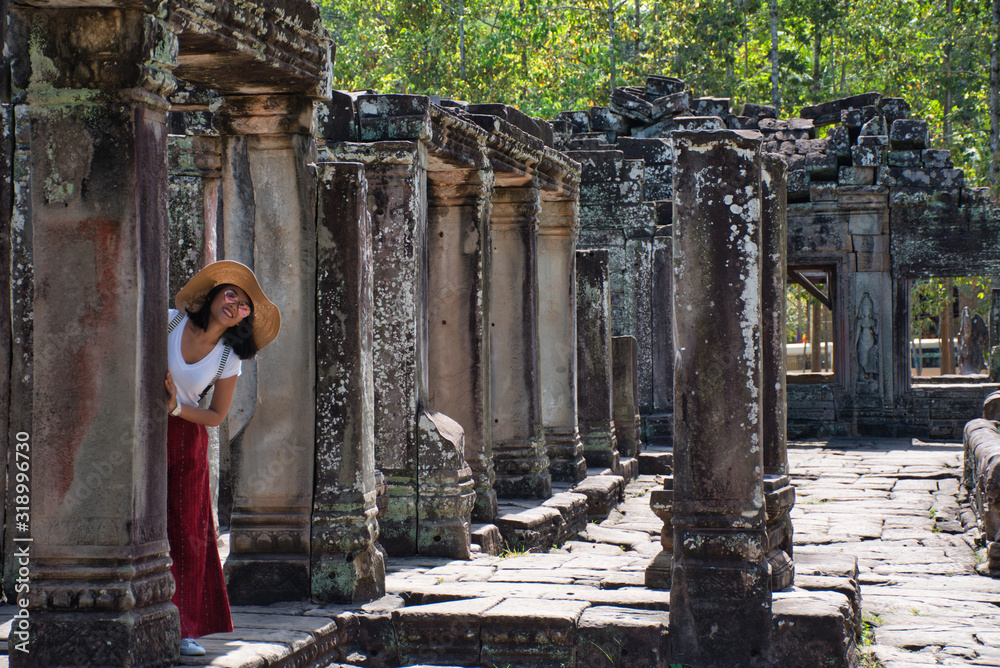 Beautiful, pretty, young Thai girl is exploring the ancient ruins of ...