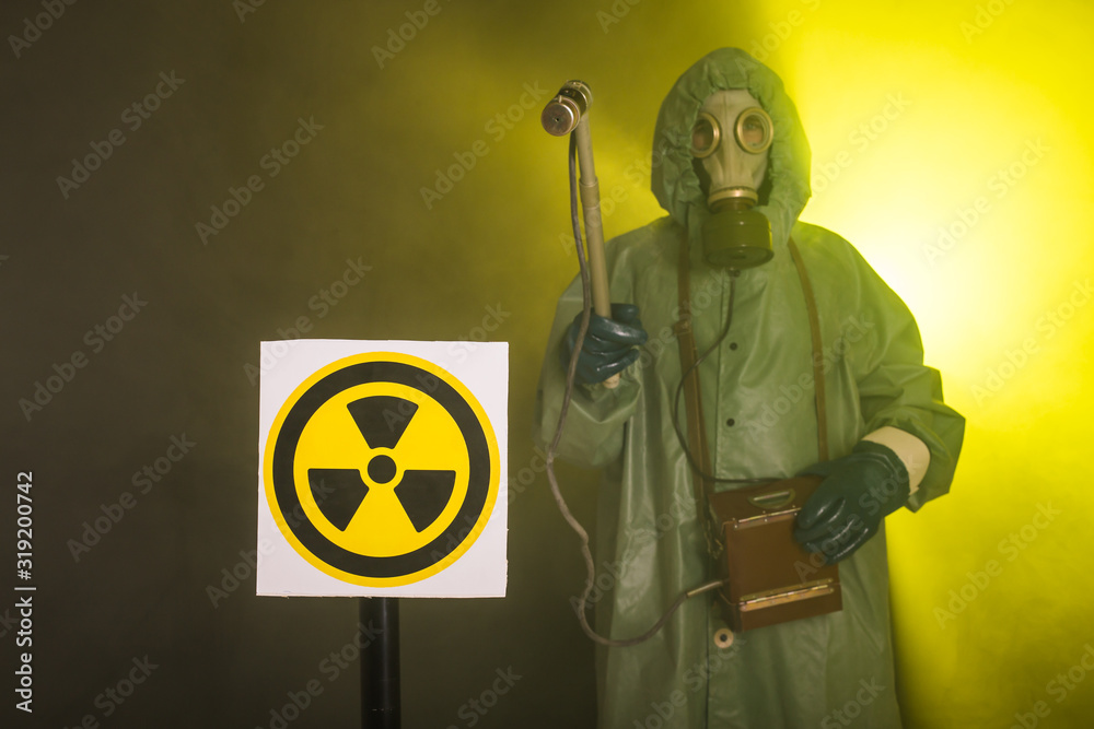 Radiation and danger concept - Man in the gas mask and chemical suit ...