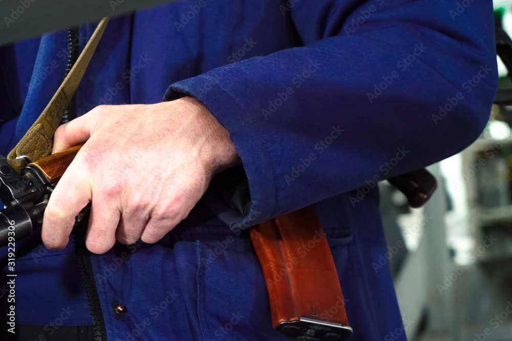 A security guards hand on a Kalashnikov. Armed departmental guards ...
