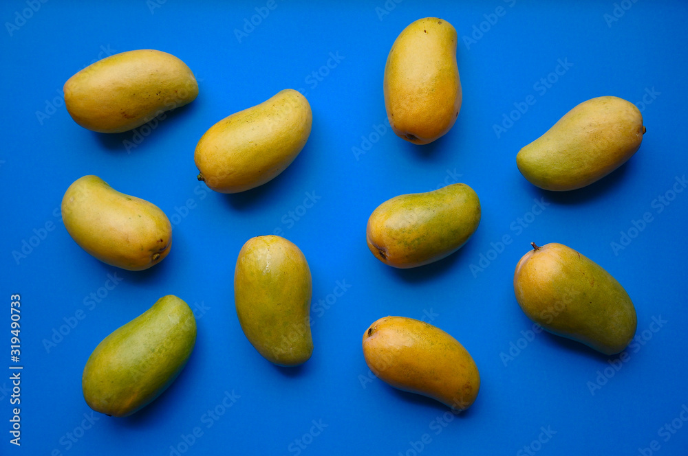 Top view of ripe mangoes in blue background Stock Photo | Adobe Stock