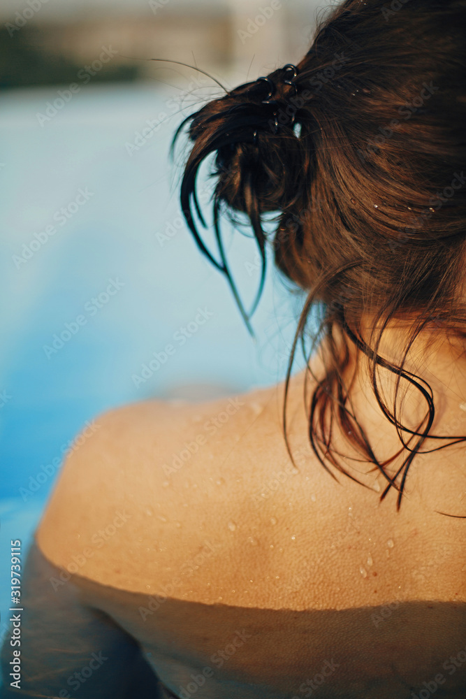 Beautiful woman back with water drops close up, relaxing in pool. Back ...