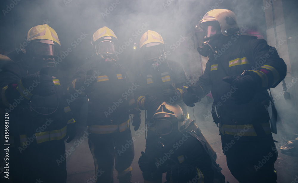 Team of fireman standing the middle of the fire extinguisher's smoke ...