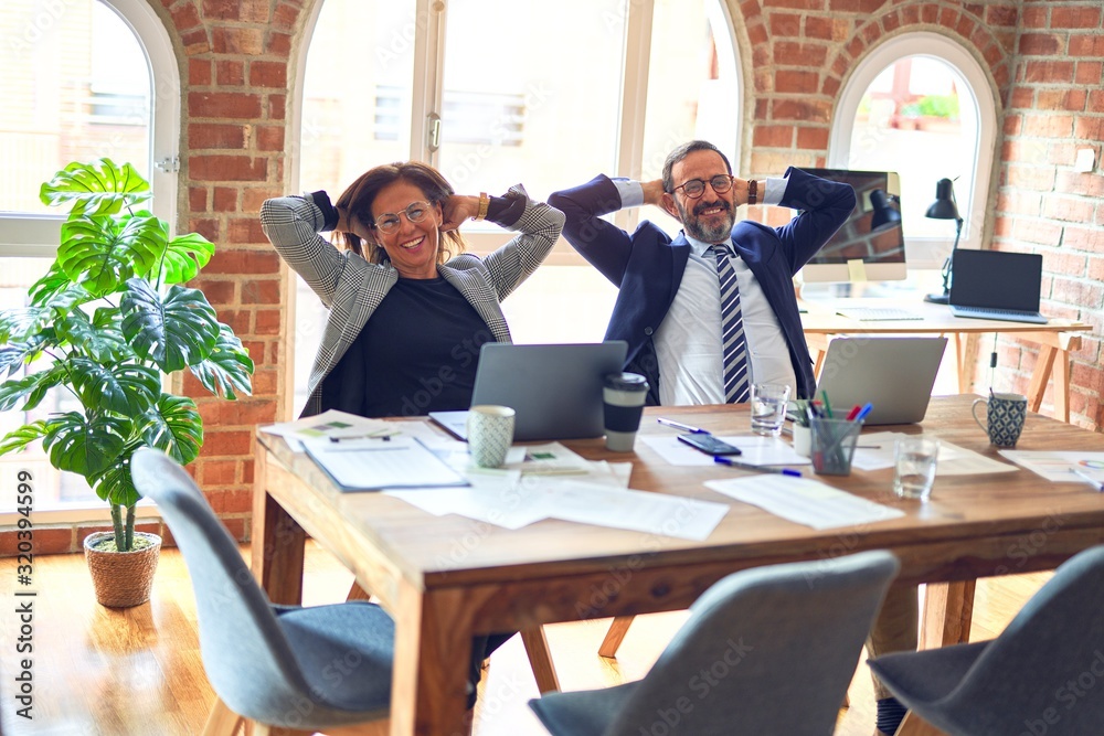 Two middle age business workers smiling happy and confident. Working ...