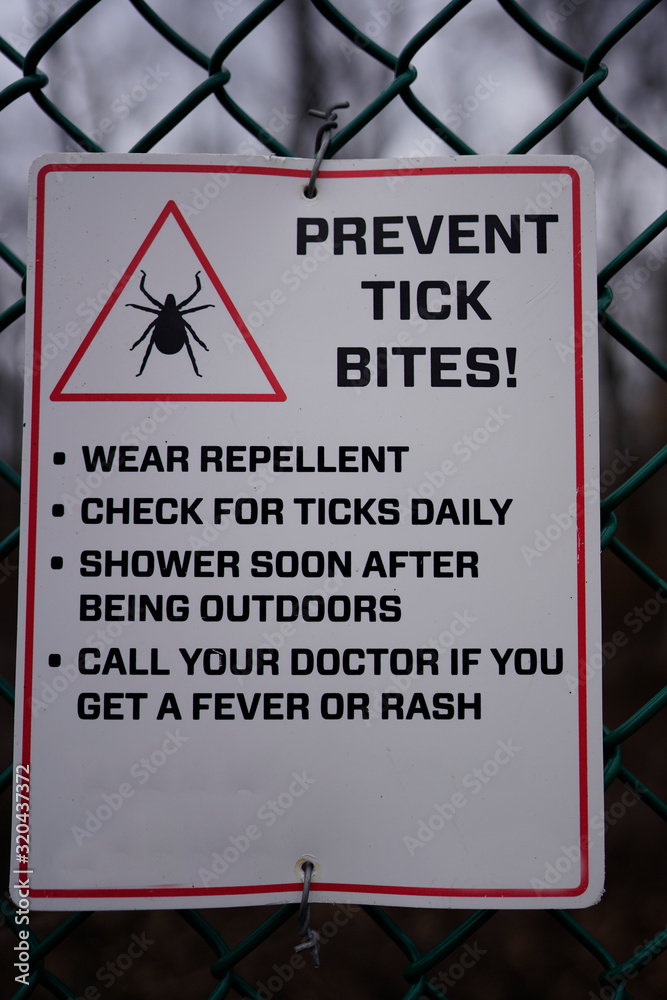 Sign warning about ticks and tick bites. Prevention measures Stock ...
