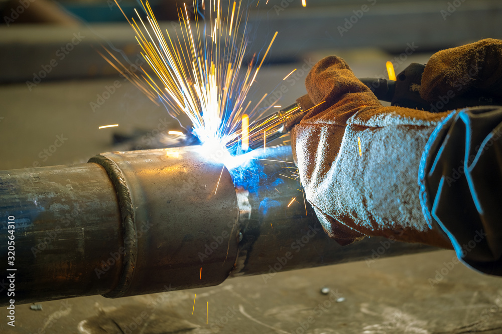 Pipe welding. The connection of the pipe with a clamp. Welder performs ...