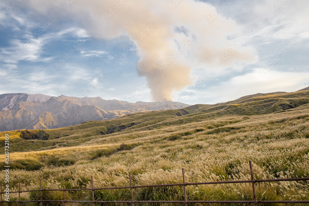 Foto de Stock Area of Aso active volcano background with smoke at Mount ...