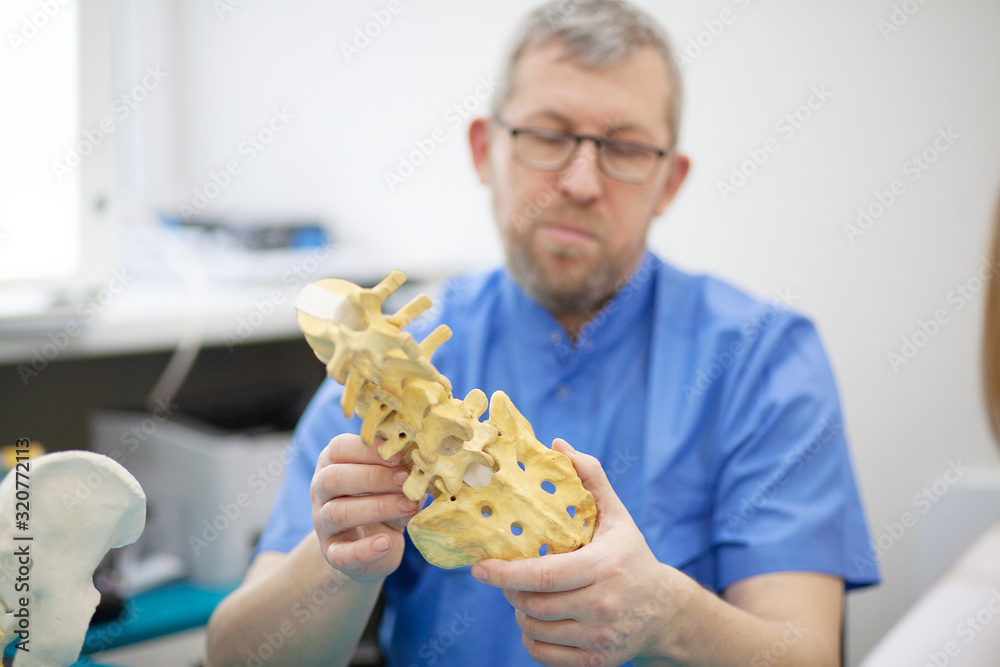 The doctor osteopath and chiropractor in the hospital explains to the ...