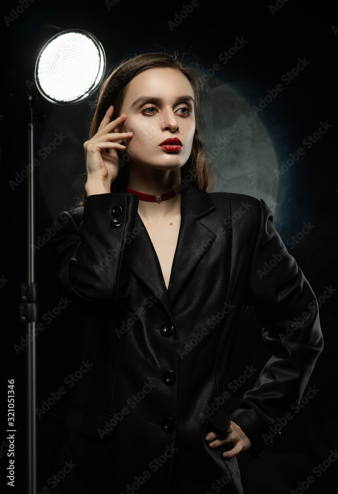 Beautiful slim girl model with red lips, wearing a black blazer ...