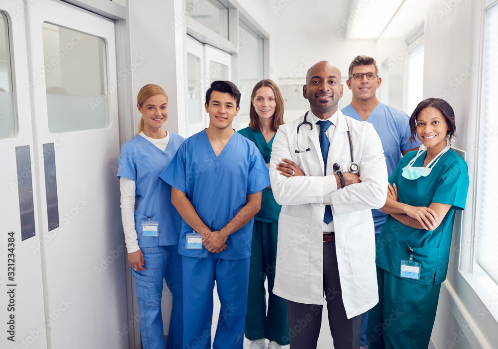 Portrait Of Multi-Cultural Medical Team Standing In Hospital Corridor ...