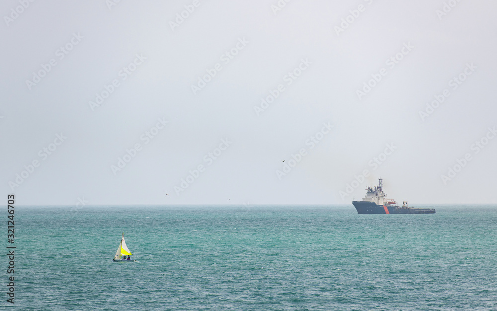 Big cruise ship and small sailing boat, size comparison, France Stock ...