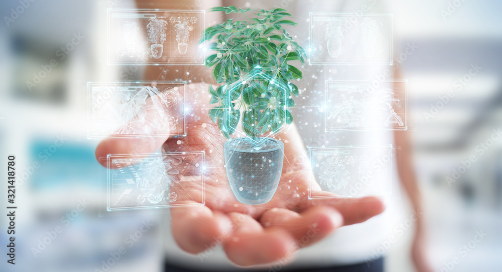 Man holding and touching holographic projection of a plant with digital ...