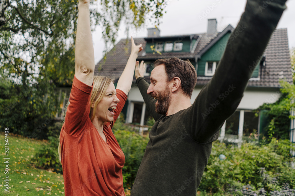 Proud home owners cheering in their garden Stock Photo | Adobe Stock