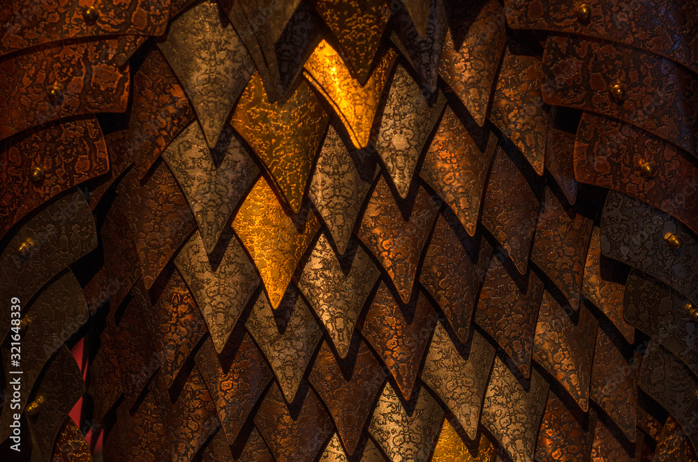 Metal scales of different shades close up. Background with golden ...