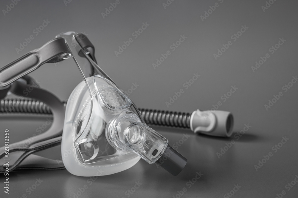Sleep apnea CPAP mask on the grey background Stock Photo | Adobe Stock