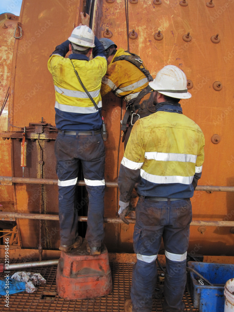 Foto de Stock Safe work practices workers wearing uniform safety hard ...