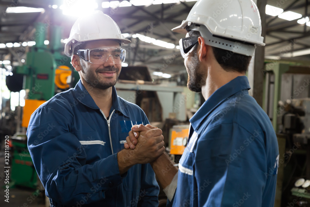 Heavy industrial worker in gloves greeting each other with handshake on ...