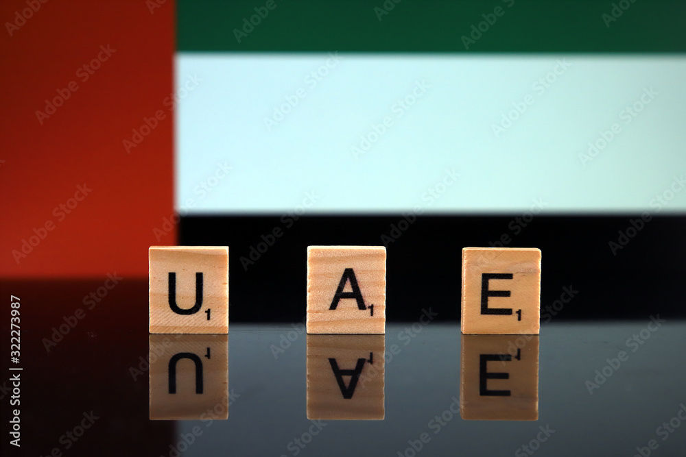 United Arab Emirates Flag and word UAE made of small wooden letters ...