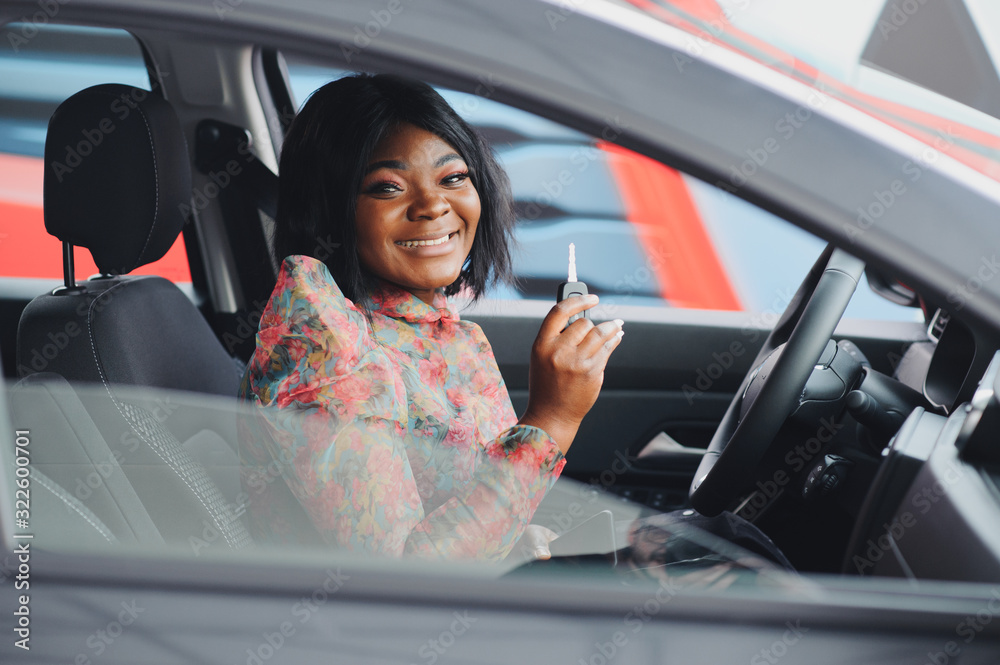Beautiful young mixed race black African American woman driving car and ...