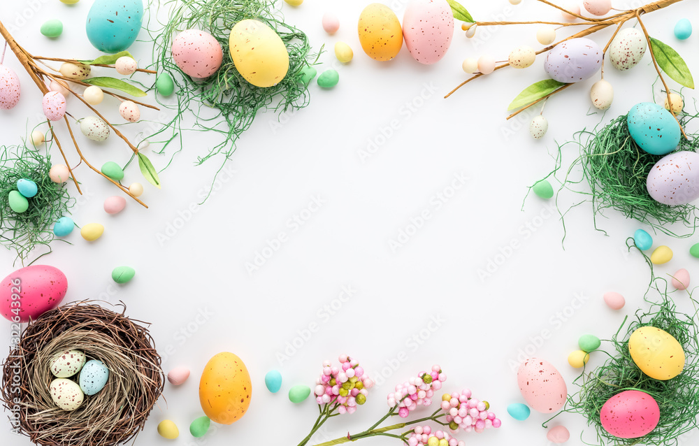 Top down view of an Easter border frame of robin's eggs and chocolate ...