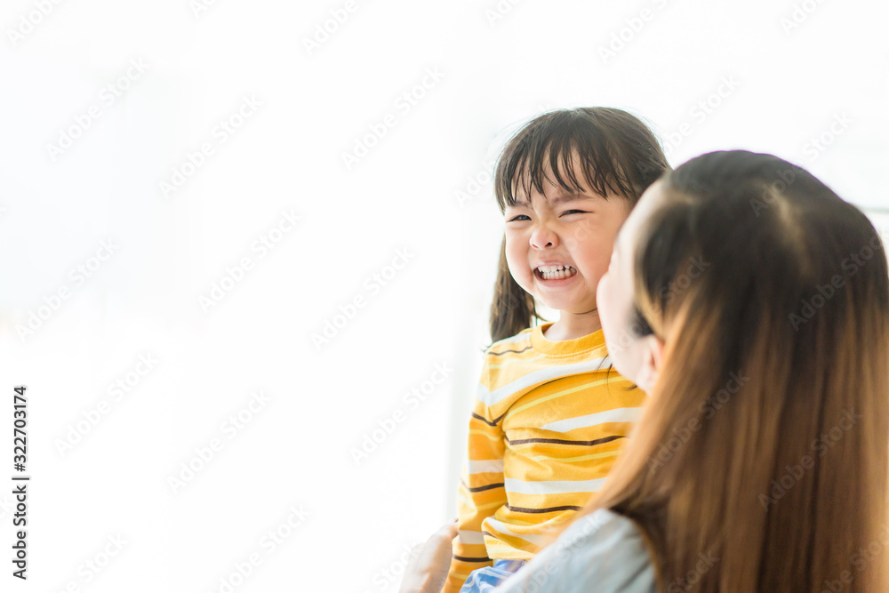 Stressed exhausted mother holding daughter crying and sadly.Little girl ...