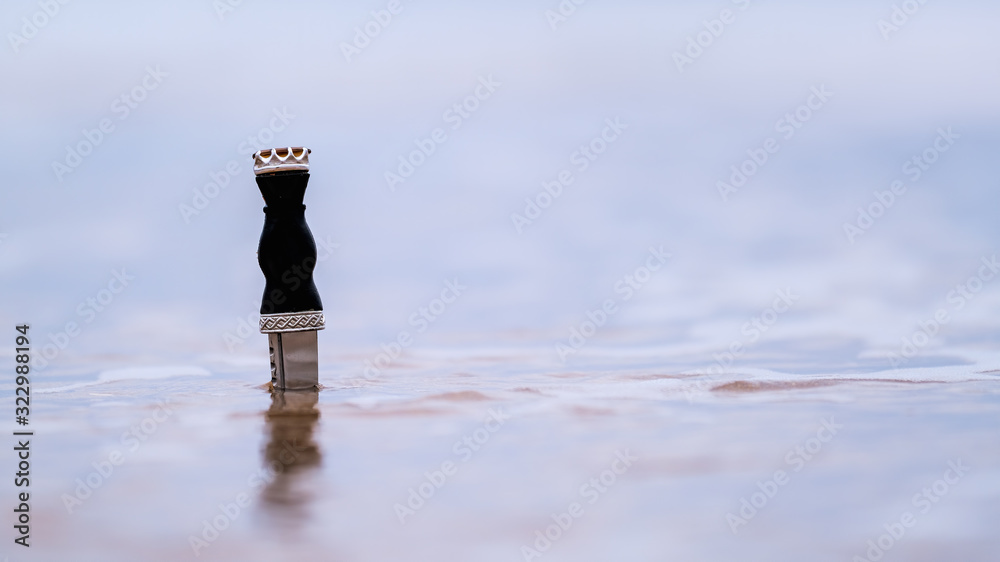 Sgian dubg Scottish dagger stuck in beach sand while being washed by ...