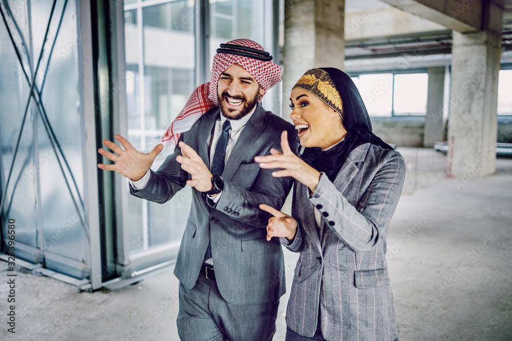 Two muslim foreign investors visiting building in construction process ...