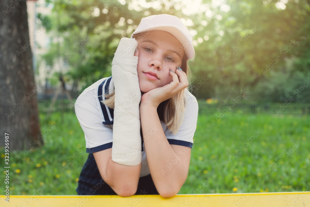 Boring teenage girl young sportswoman with arm injury outdoors Stock ...