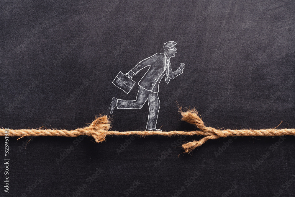 Illustrated businessman is walking on a thiny and frayed rope ...