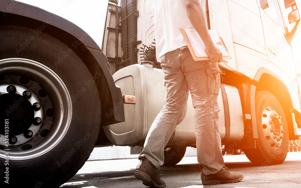 Truck driver holding clipboard inspecting safety vehicle maintenance ...