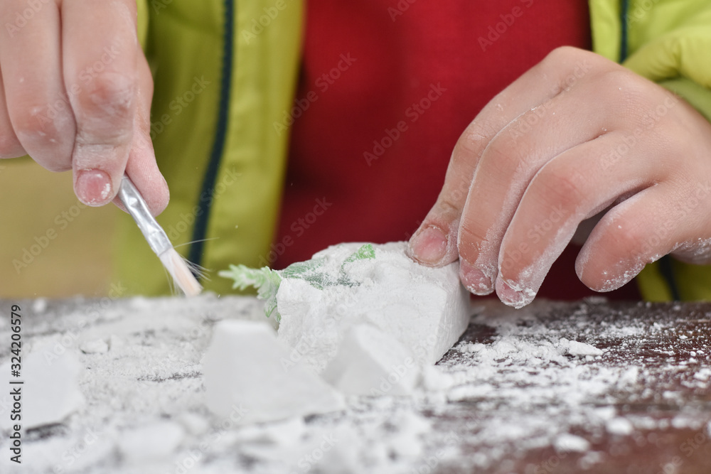 Children having fun with archaeology excavation kit. Boy plays an ...