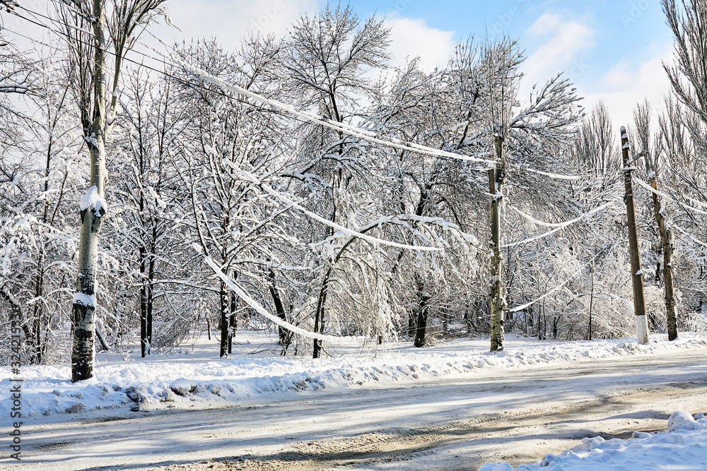 Electric power line hanging down under the weight of snow. Weather ...