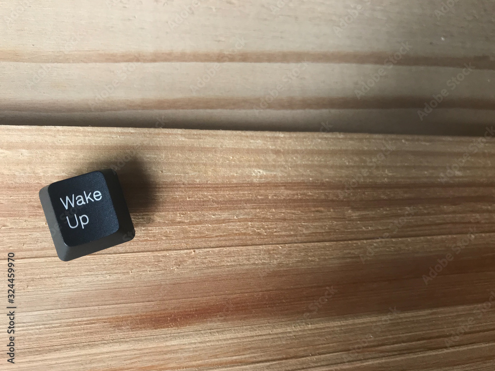 wake up black button from computer keyboard put on natural rubber wood ...