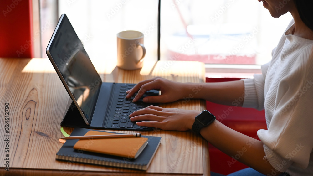Side shot of young beautiful woman working as writer typing on computer ...