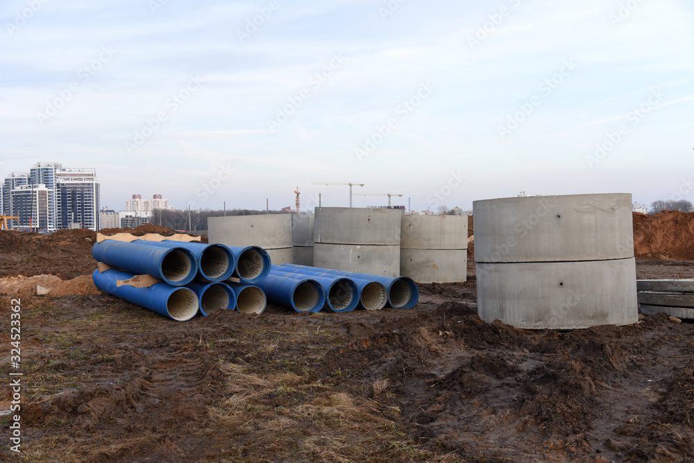 Installation of concrete sewer wells in the ground at the construction ...