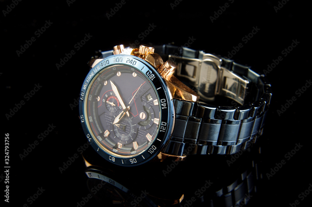 Foto Professional luxury golden blue male watch on the black reflective ...