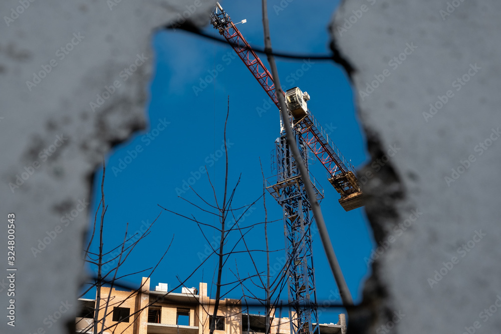 Crane on construction site. Crane and building under construction with ...