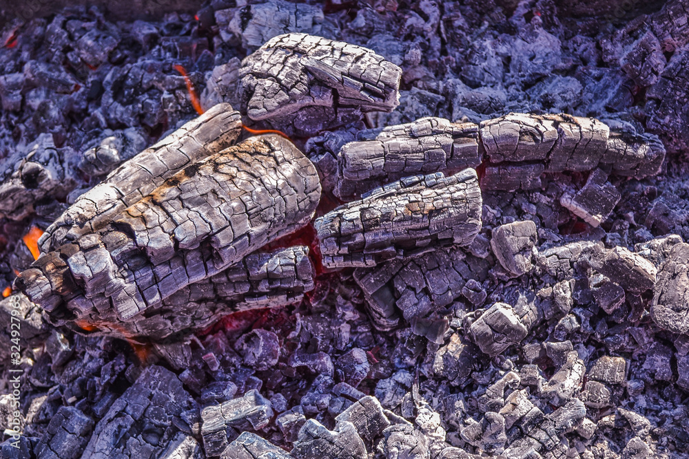 Smoldering ashes of a bonfire. Incandescent orange and red embers ...