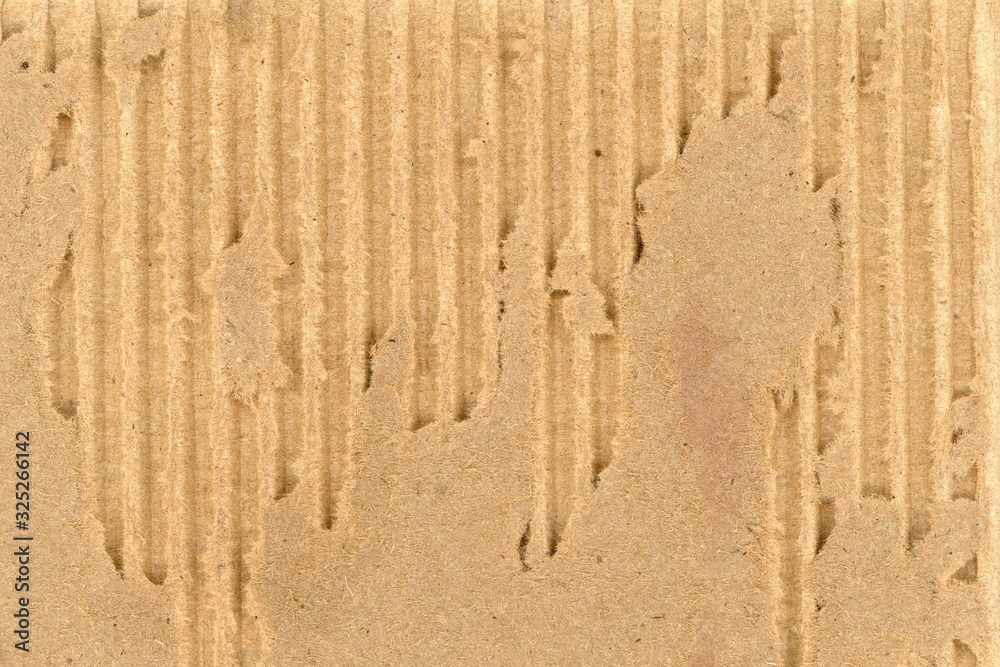 ripped damaged corrugated cardboard background, shredded brown paper ...
